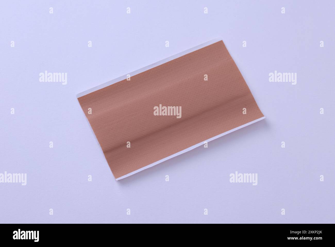 Single large bandage plaster close-up shot isolated on white background ...