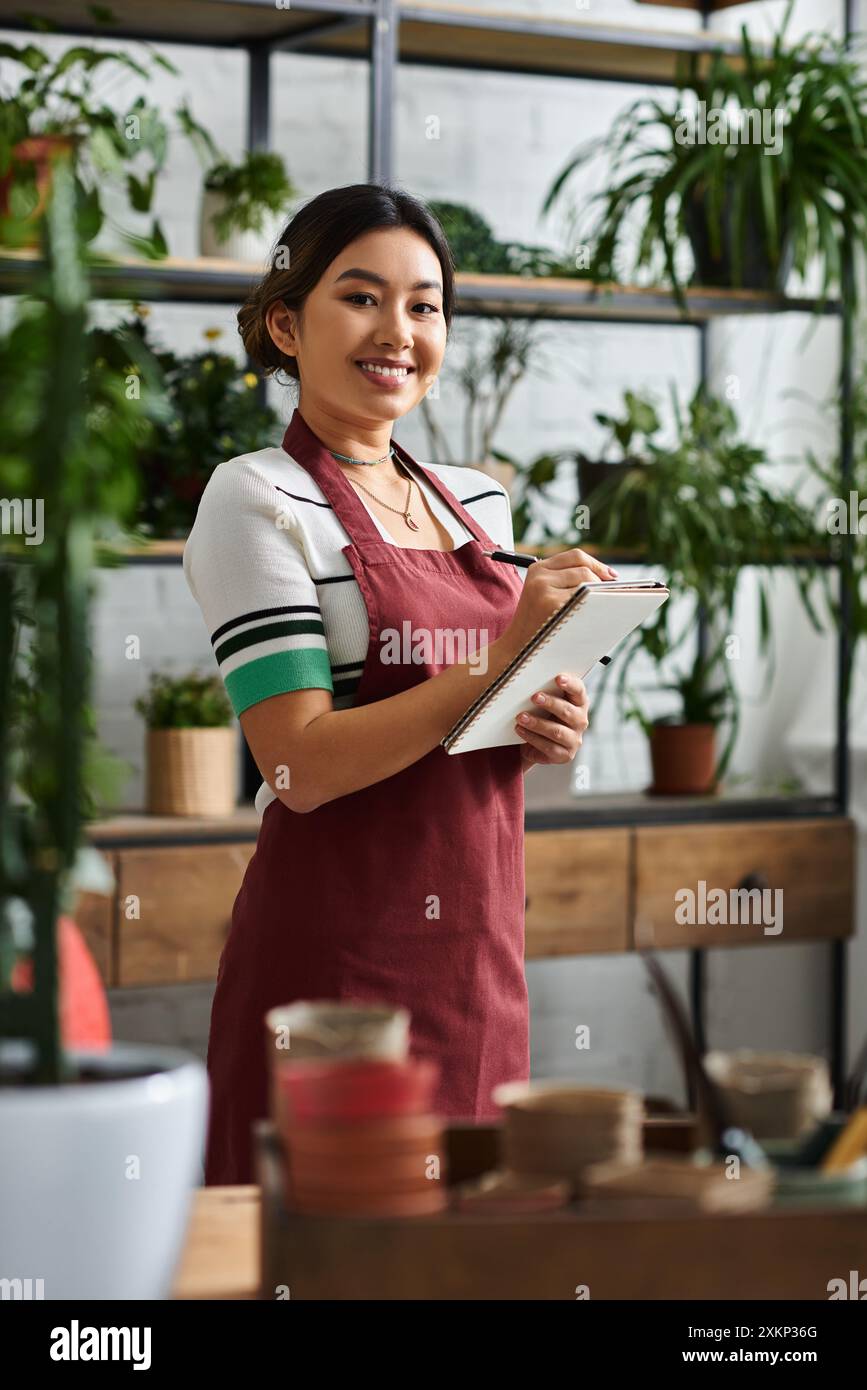 Young asian woman watering flowers hi-res stock photography and images - Alamy