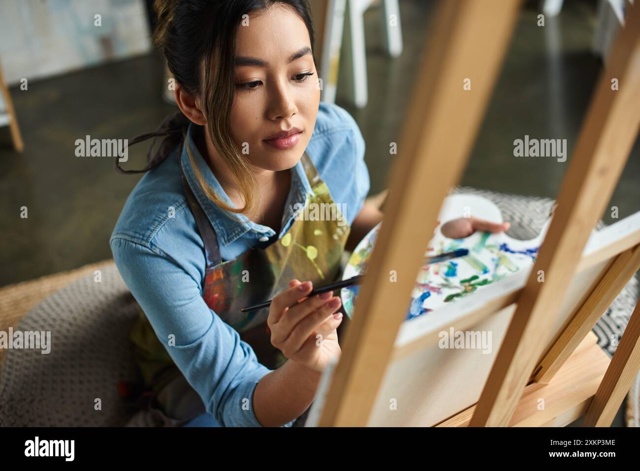 Concentrated artist painting on canvas hi-res stock photography and images - Alamy