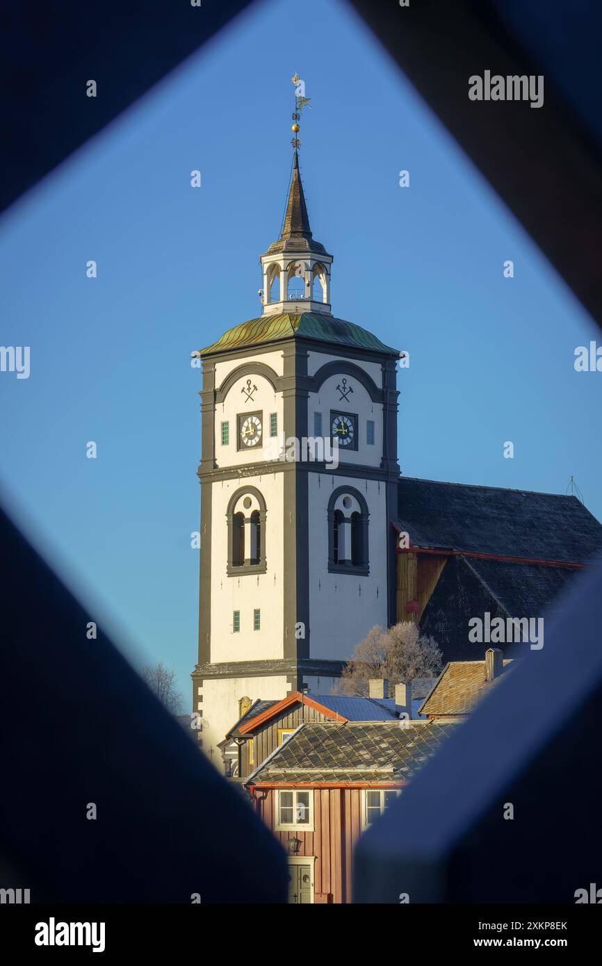 The Roros Church stands amidst of traditional Scandinavian wooden homes ...