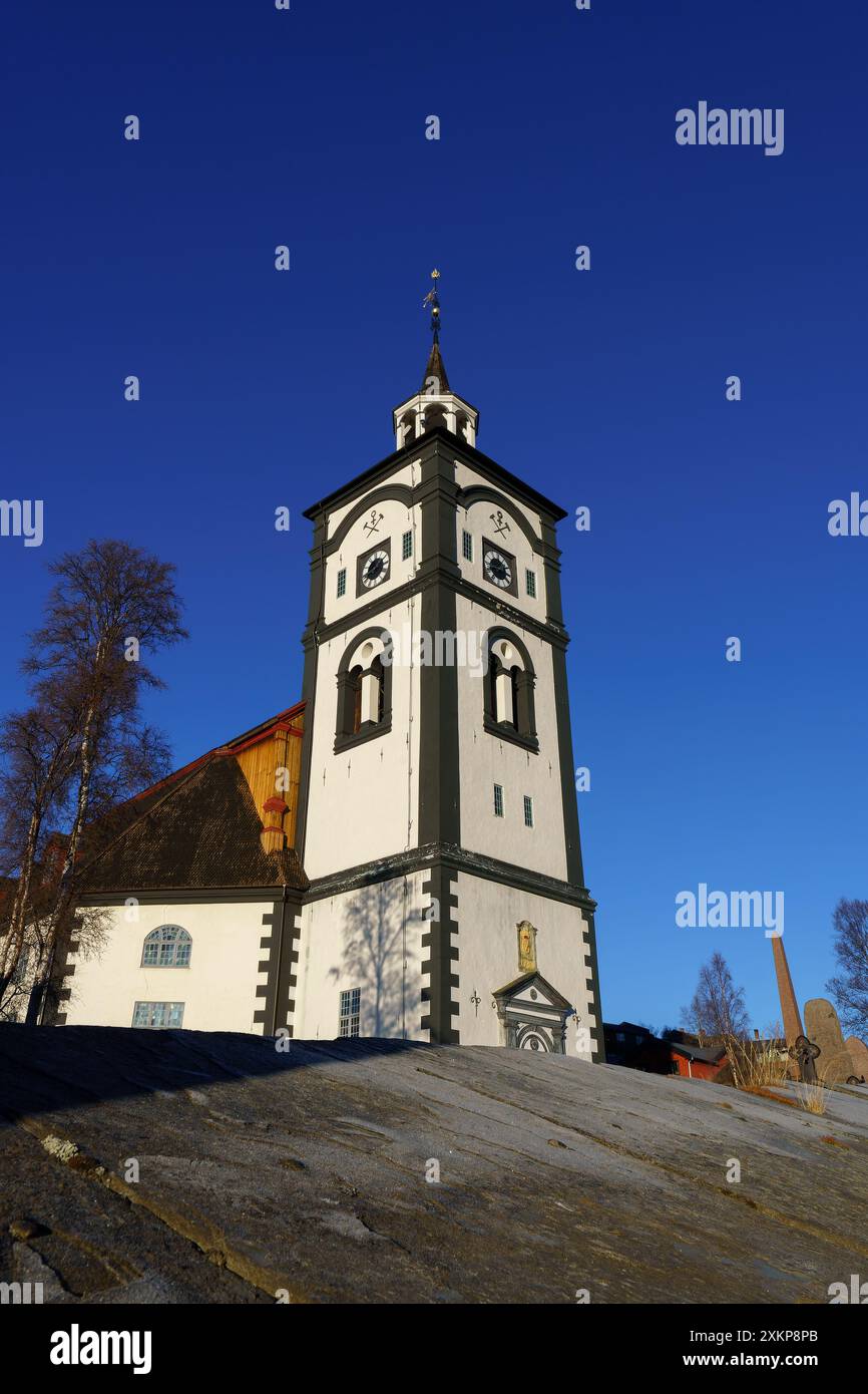 The Roros Church stands amidst of traditional Scandinavian wooden homes ...