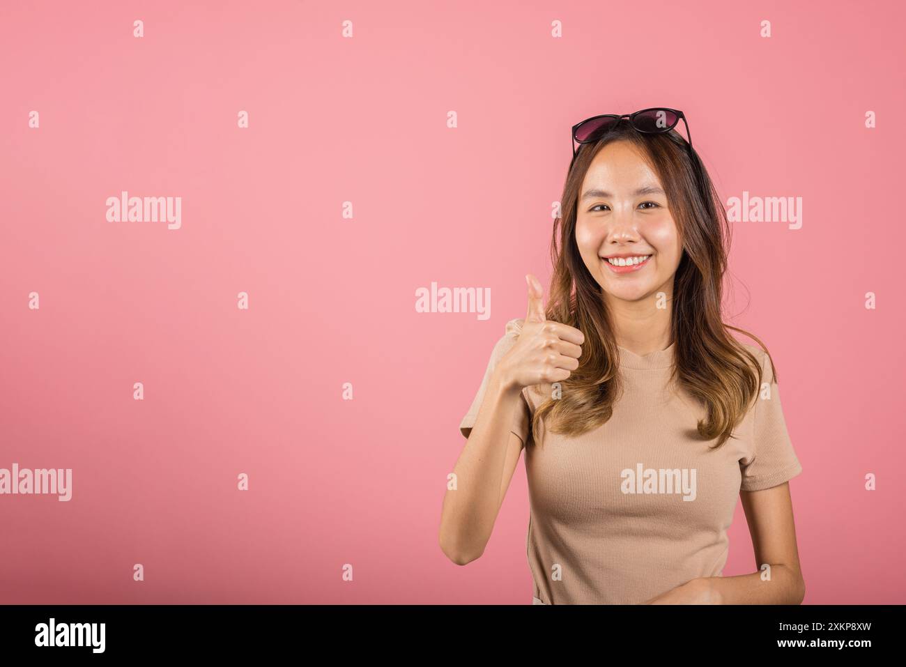 woman smiling she standing made finger thumbs up Stock Photo - Alamy