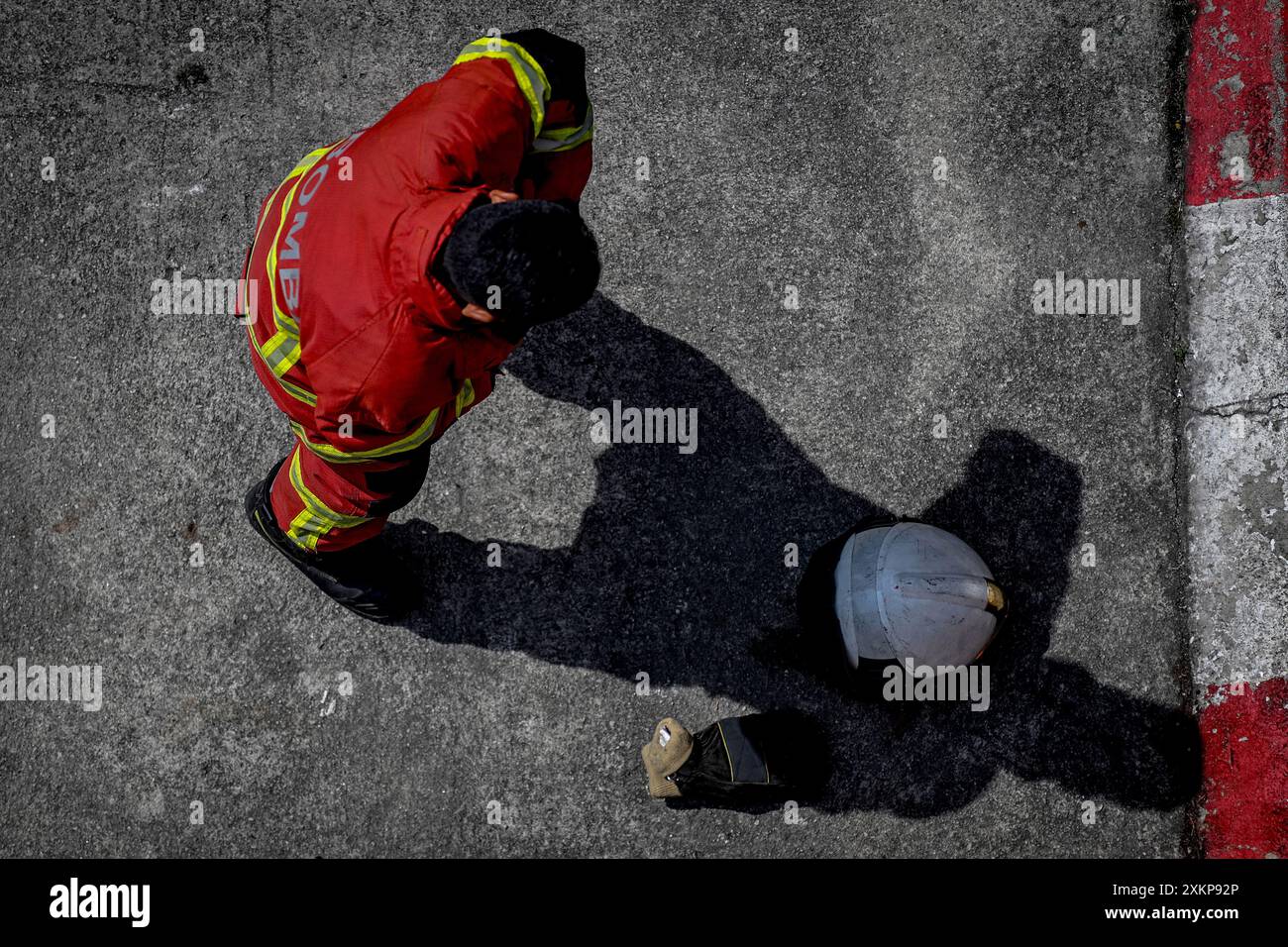 A firefighter puts on firefighter uniforms during a firefighting skills ...