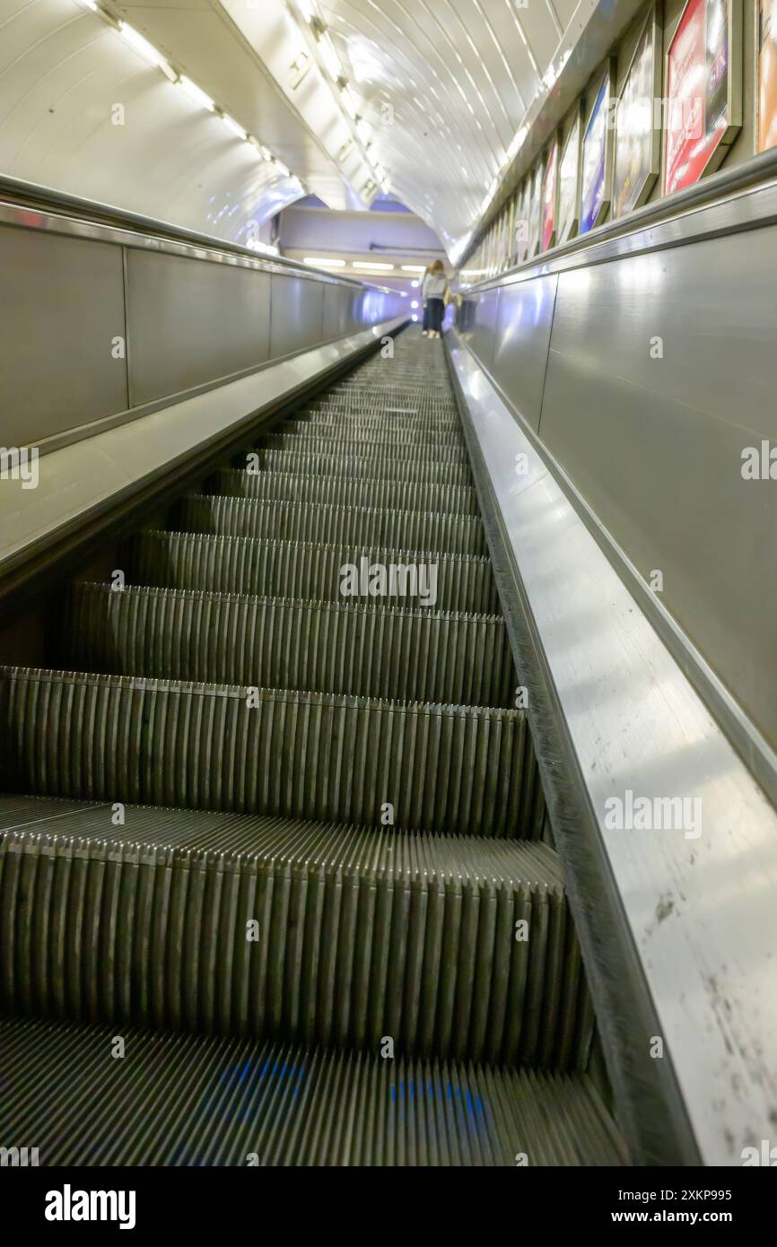 An empty escalator going down towards a London Tube station, empty ...