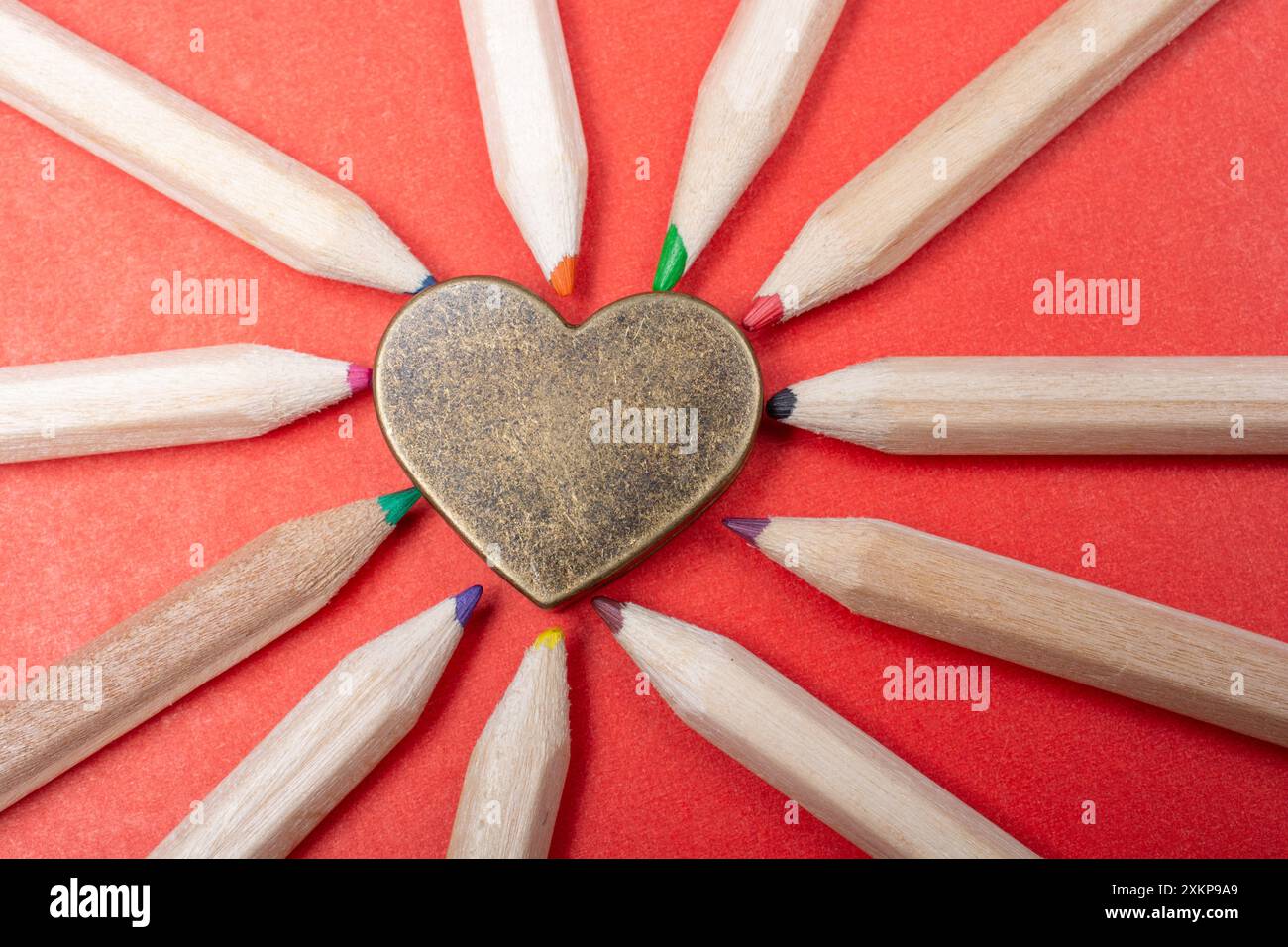 Heart laid out with sharpened multi-colored pencils Stock Photo - Alamy