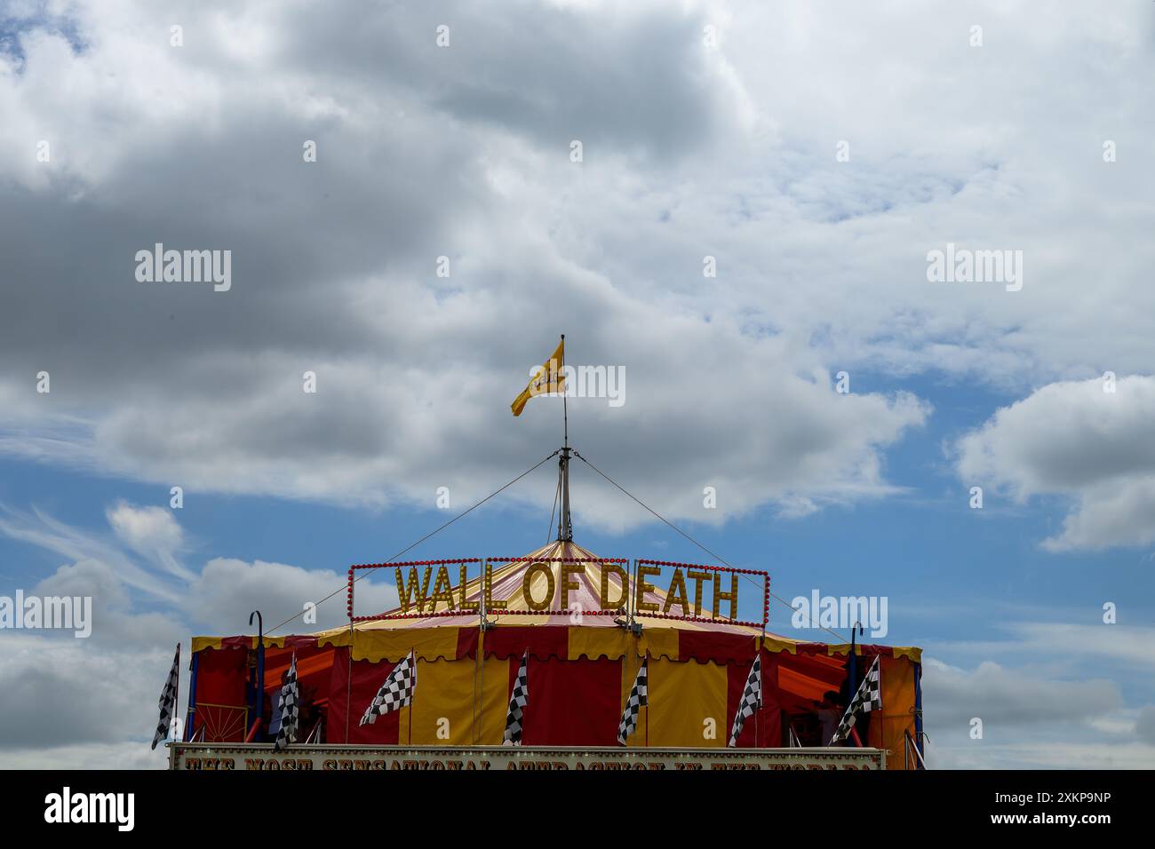 Bright and colorful carnival attraction featuring the Wall of Death ...
