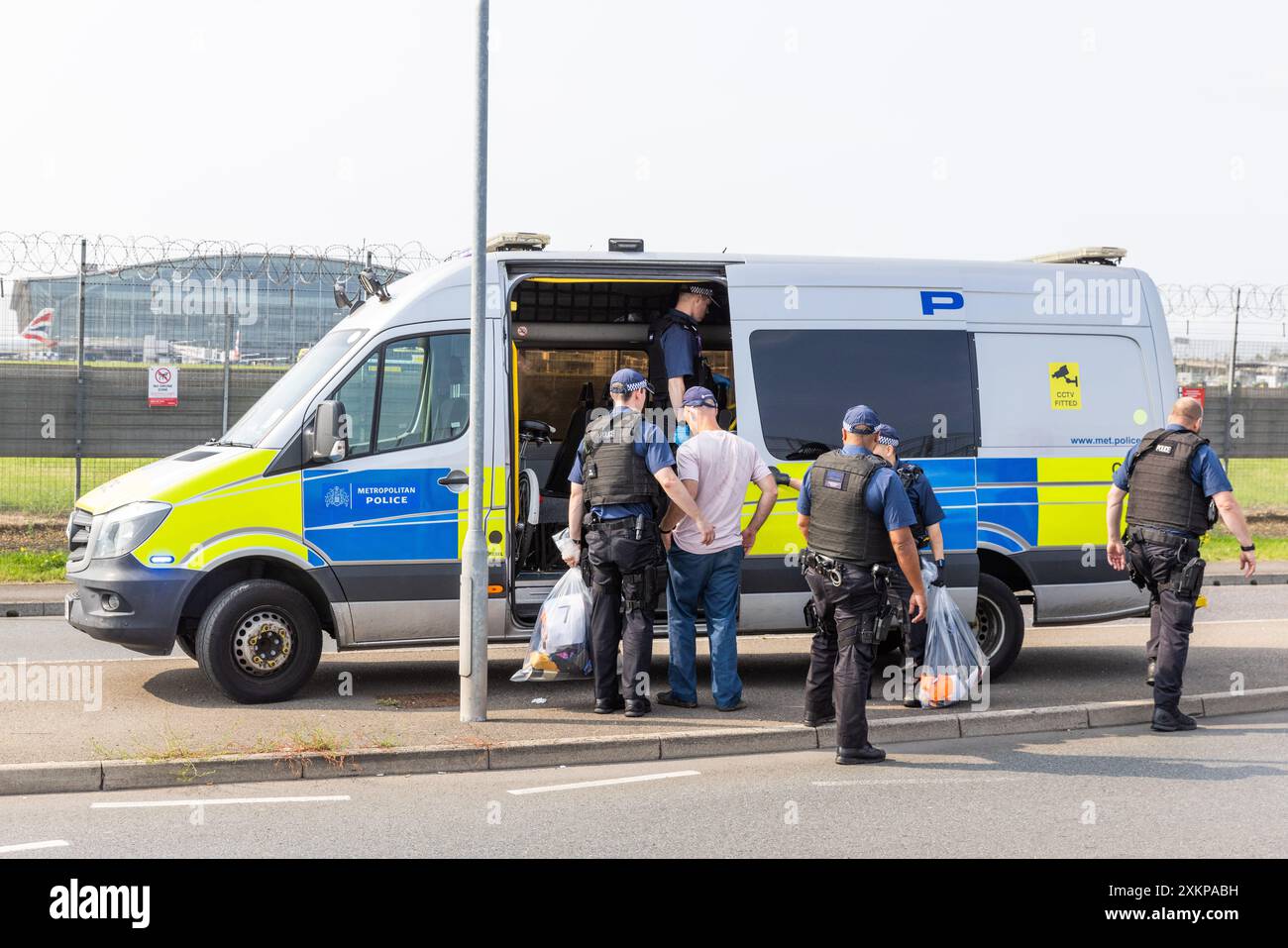 London, UK. 24 JUL, 2024. Police load an arrested activist into the ...
