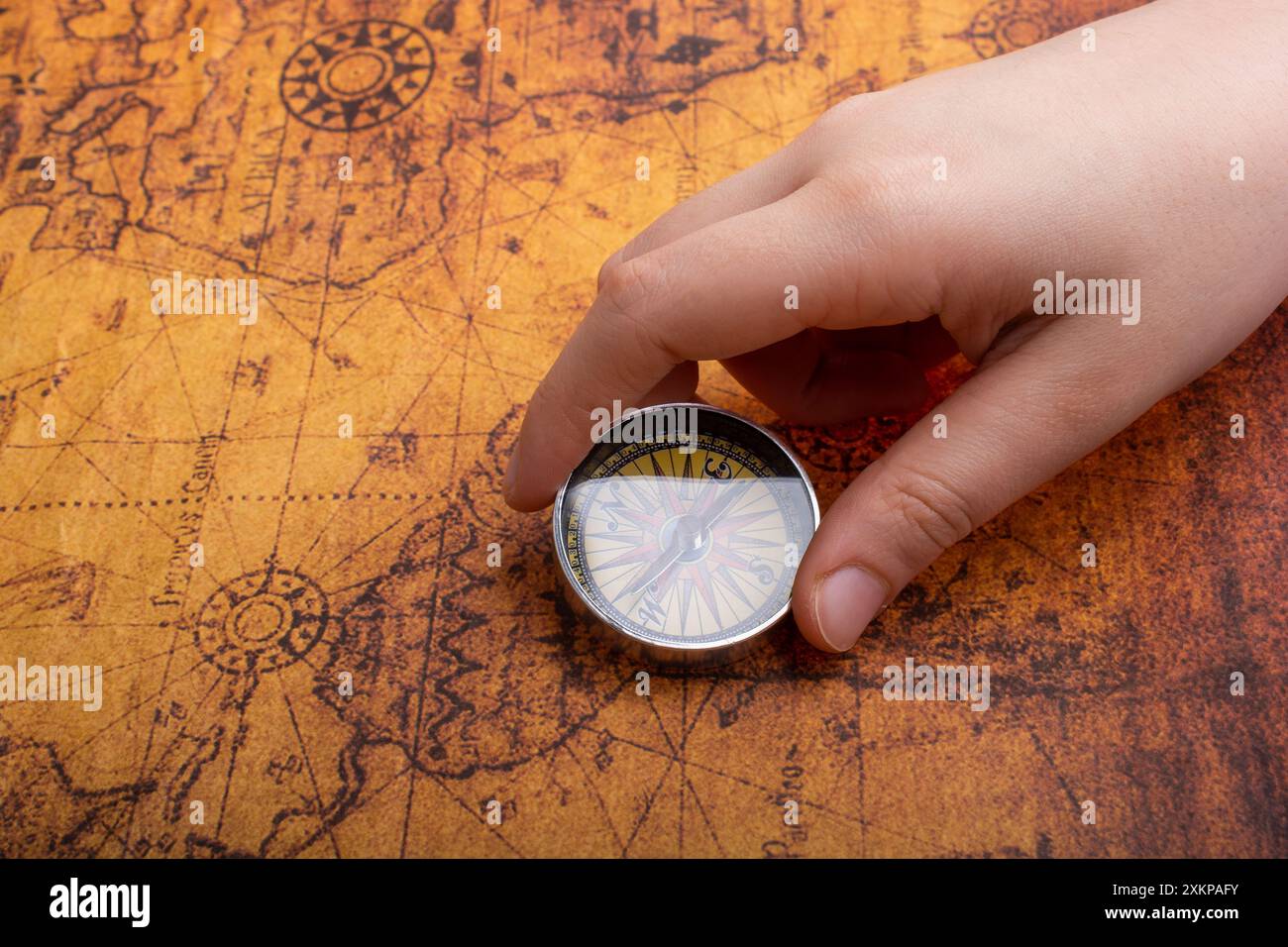 Hand is holding a magnetic compass on black background Stock Photo - Alamy