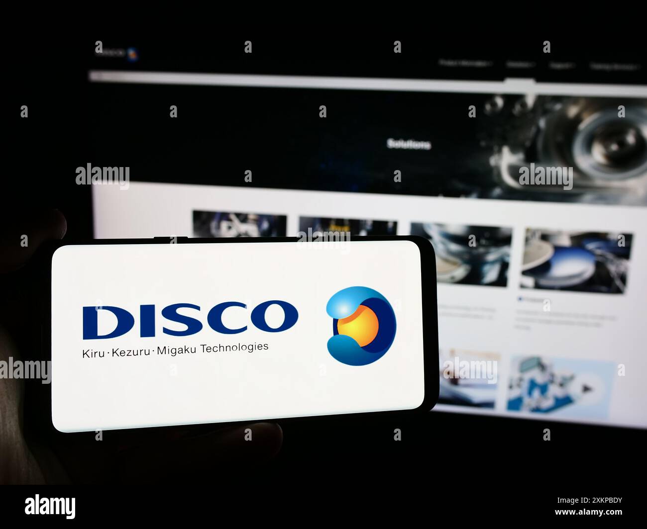 Person holding mobile phone with logo of Japanese precision tools ...