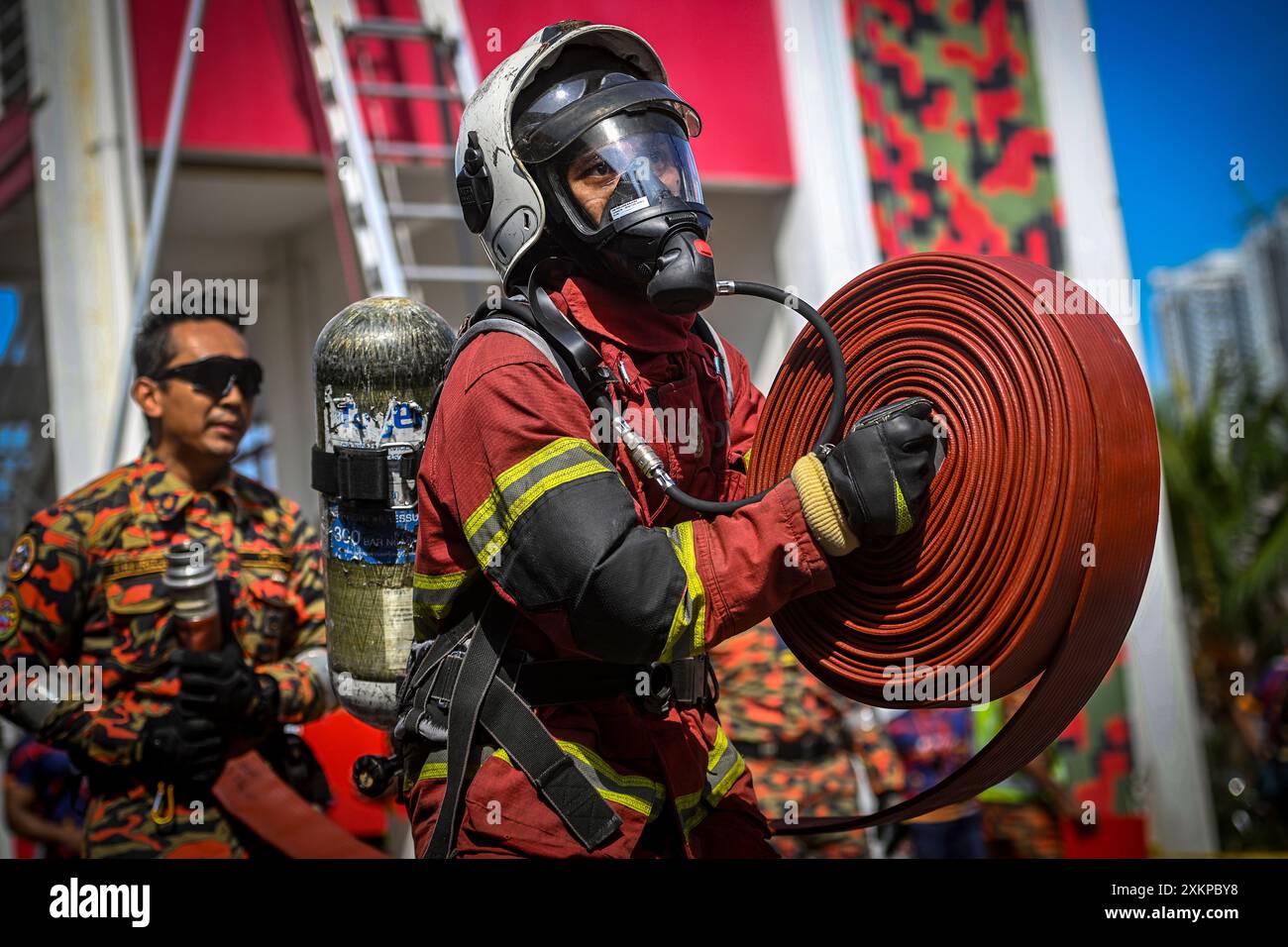 Kuala Lumpur, Malaysia. 29th May, 2024. A firefighter pulls a tube in ...