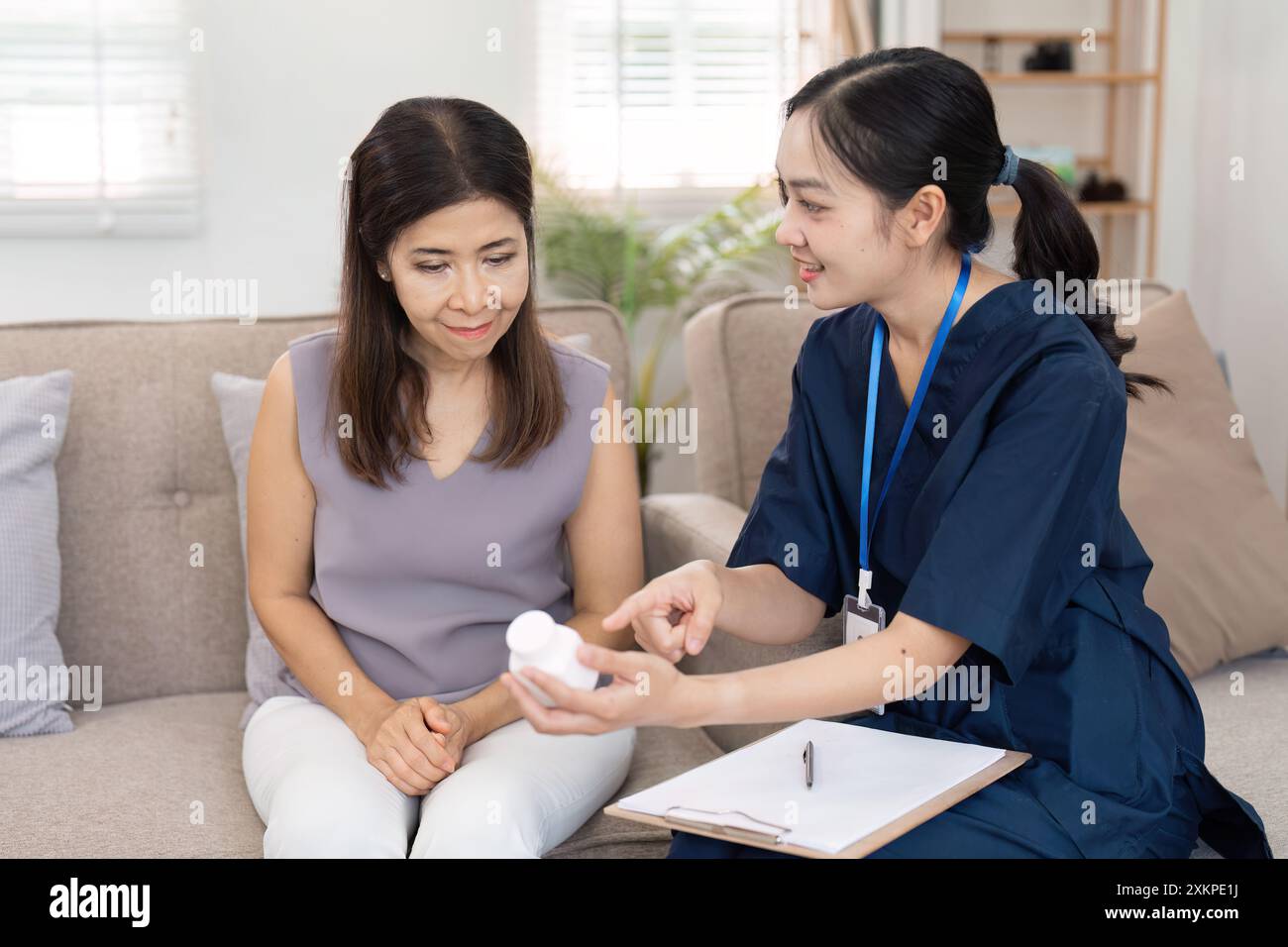 Healthcare Professional Assisting Patient at Home with Medication ...