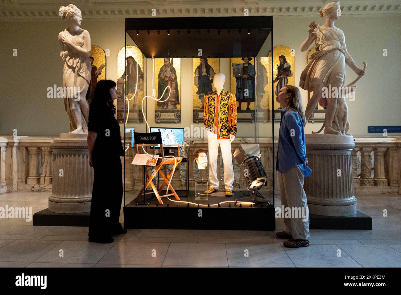 Gallery assistants look at an outfit worn by Taylor Swift in the The ...