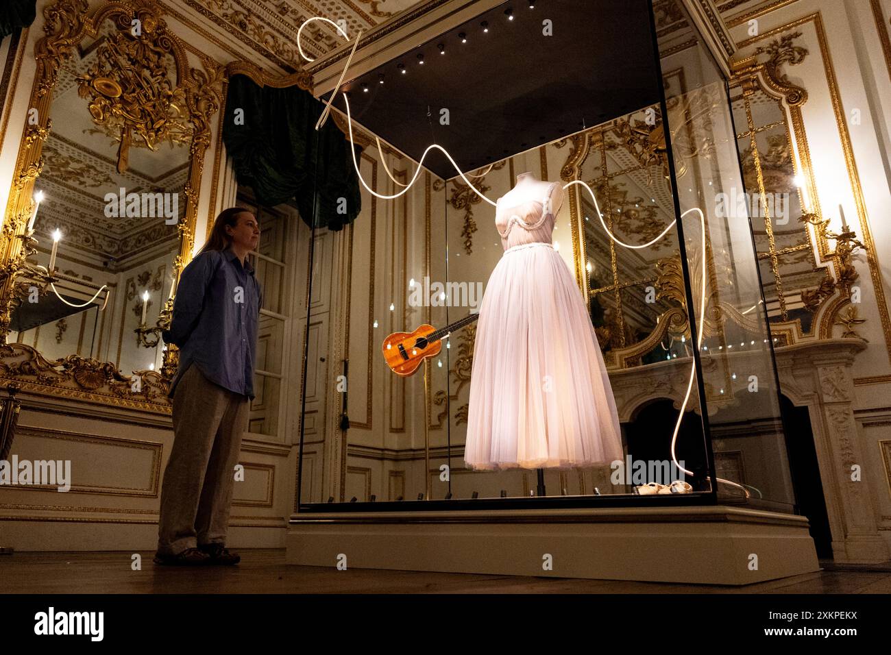 A gallery assistant looks at the outfit worn by Taylor Swift on the ...