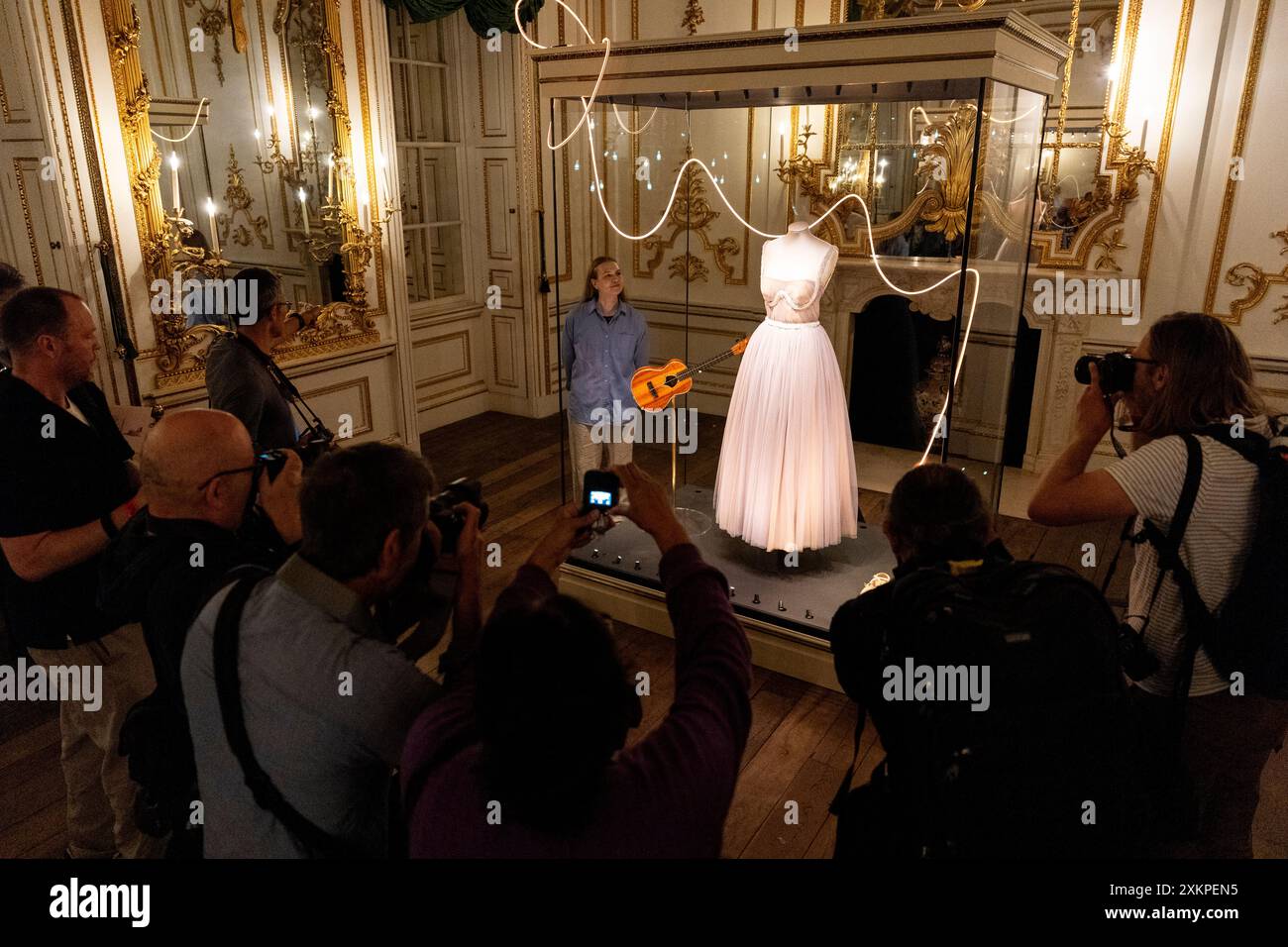 A gallery assistant looks at the outfit worn by Taylor Swift on the ...