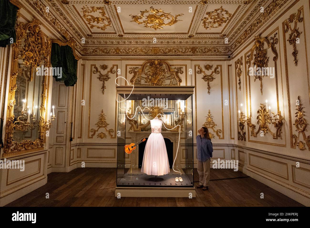 A gallery assistant looks at the outfit worn by Taylor Swift on the ...