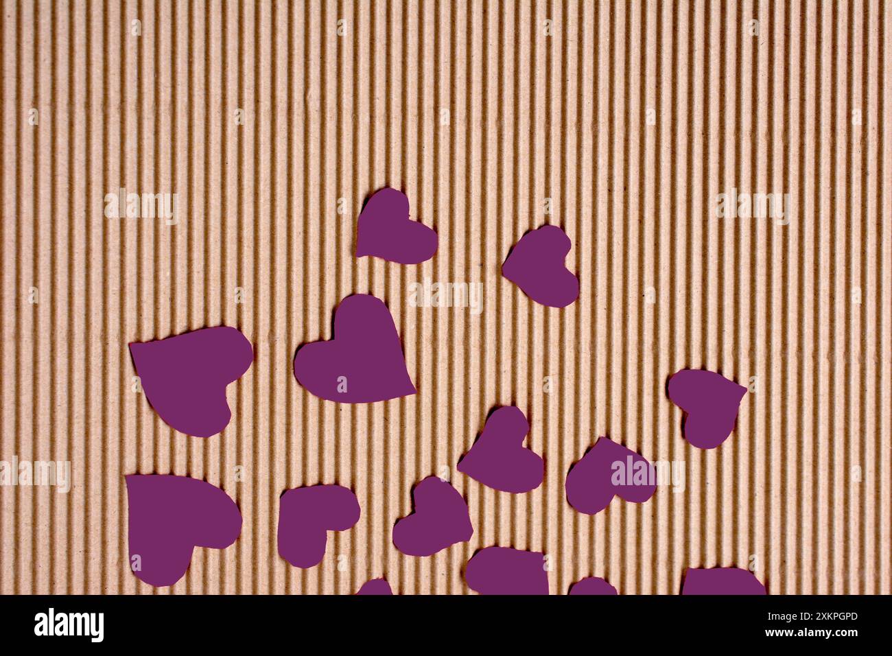 Red color paper hearts on a brown color cardboard Stock Photo - Alamy