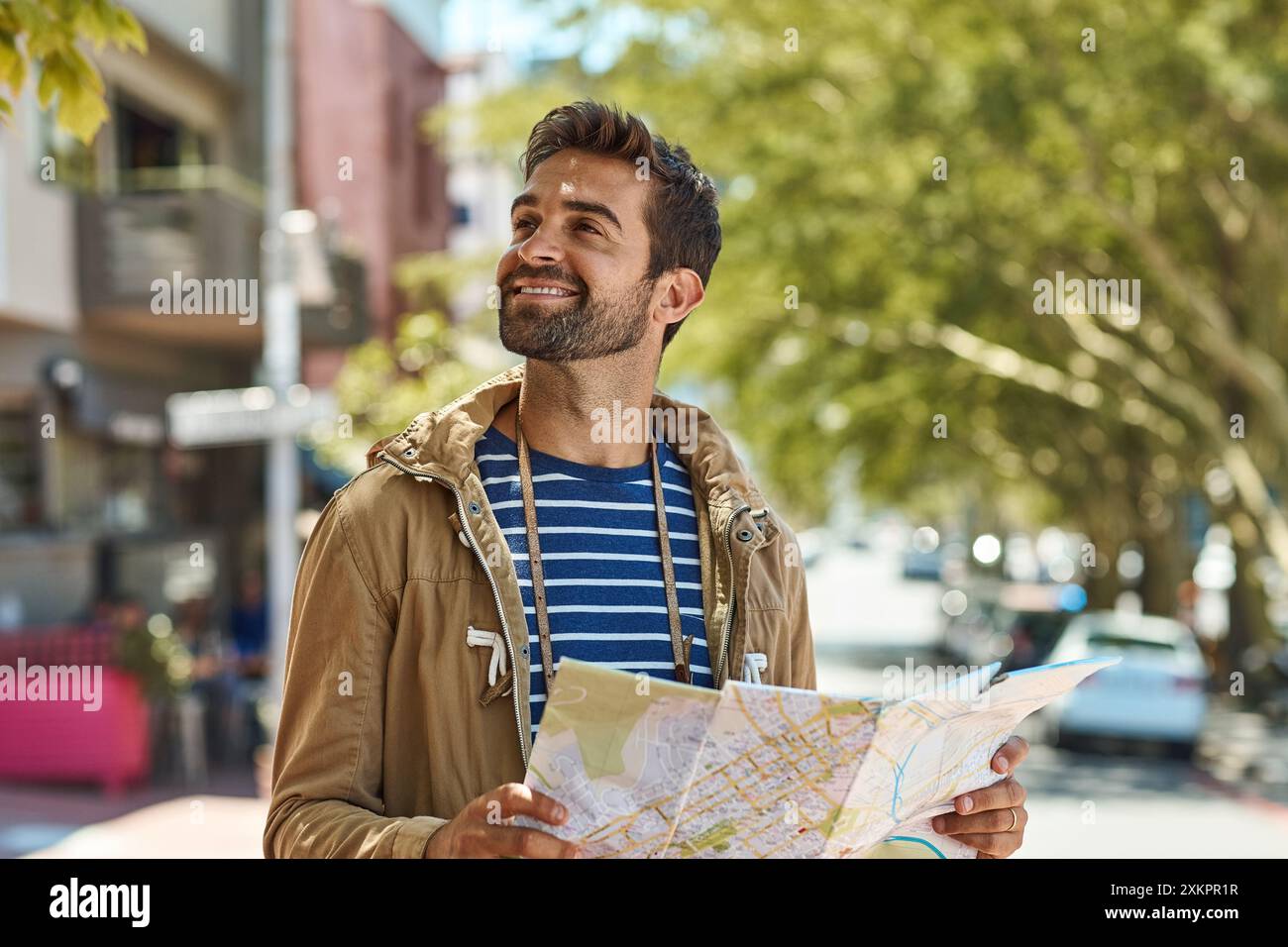 Happy man, travel and city sightseeing in outdoor, map and urban ...