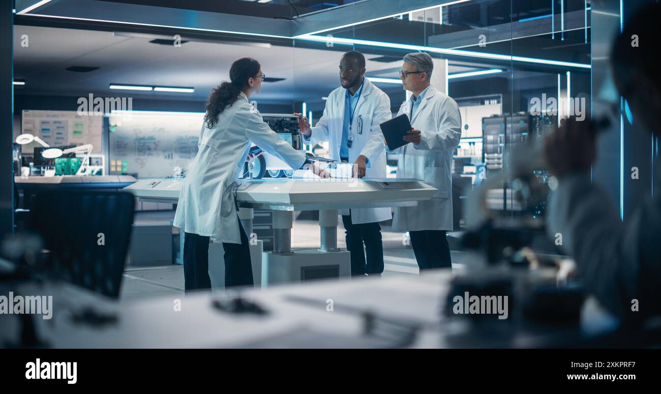 Industrial Robotics Specialists Working on a Mobile Robot, Using a ...