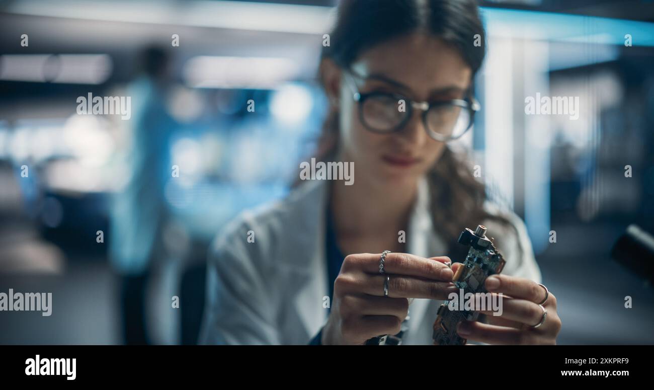 Focused Professional Female Engineer Working on Electronic Circuit ... Focused Professional Female Engineer Working on Electronic Circuit ...