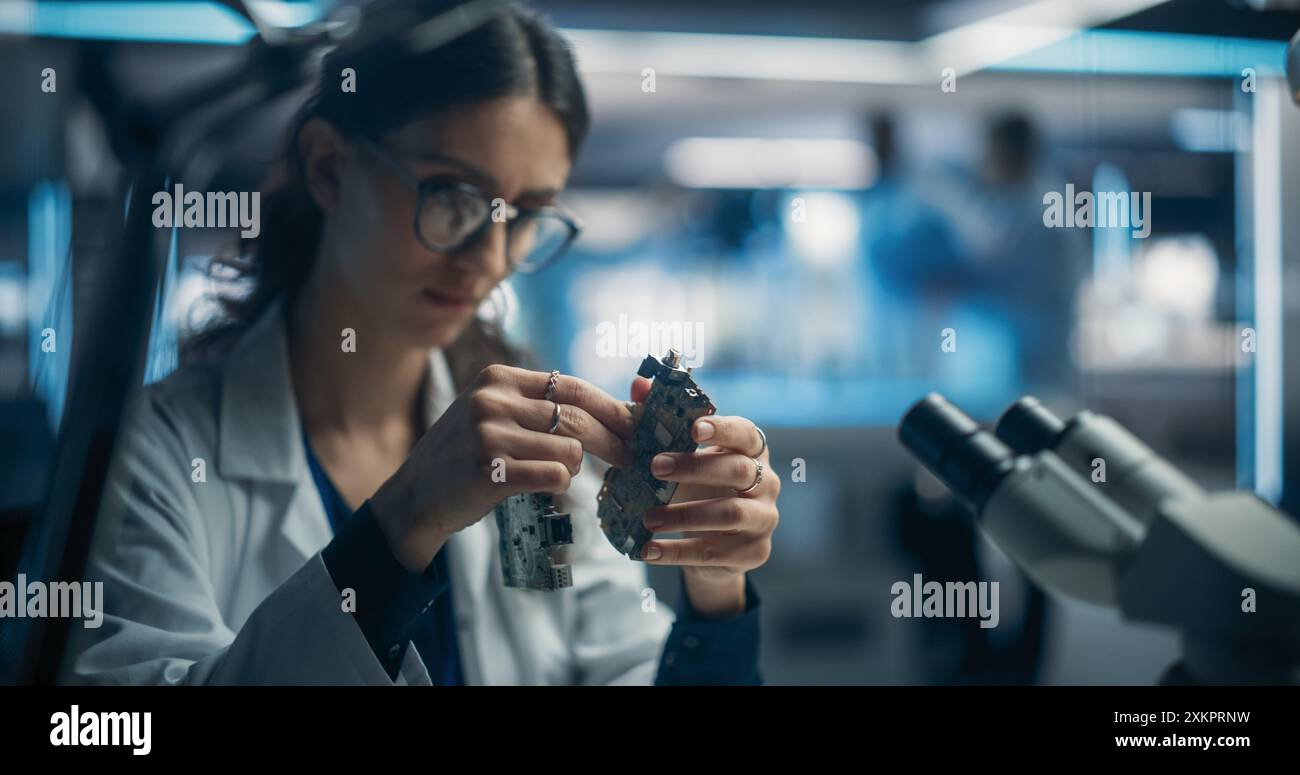 Focused Professional Female Engineer Working on Electronic Circuit ... Focused Professional Female Engineer Working on Electronic Circuit ...
