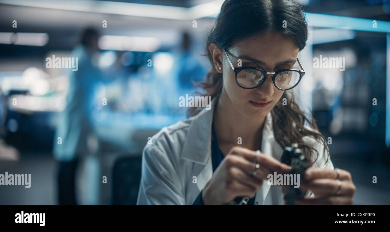 Focused Professional Female Engineer Working on Electronic Circuit ...