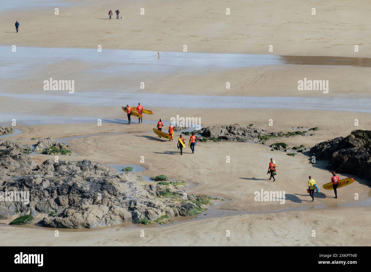 Surf Rescue surfers carrying their surf rescue boards walking across ...