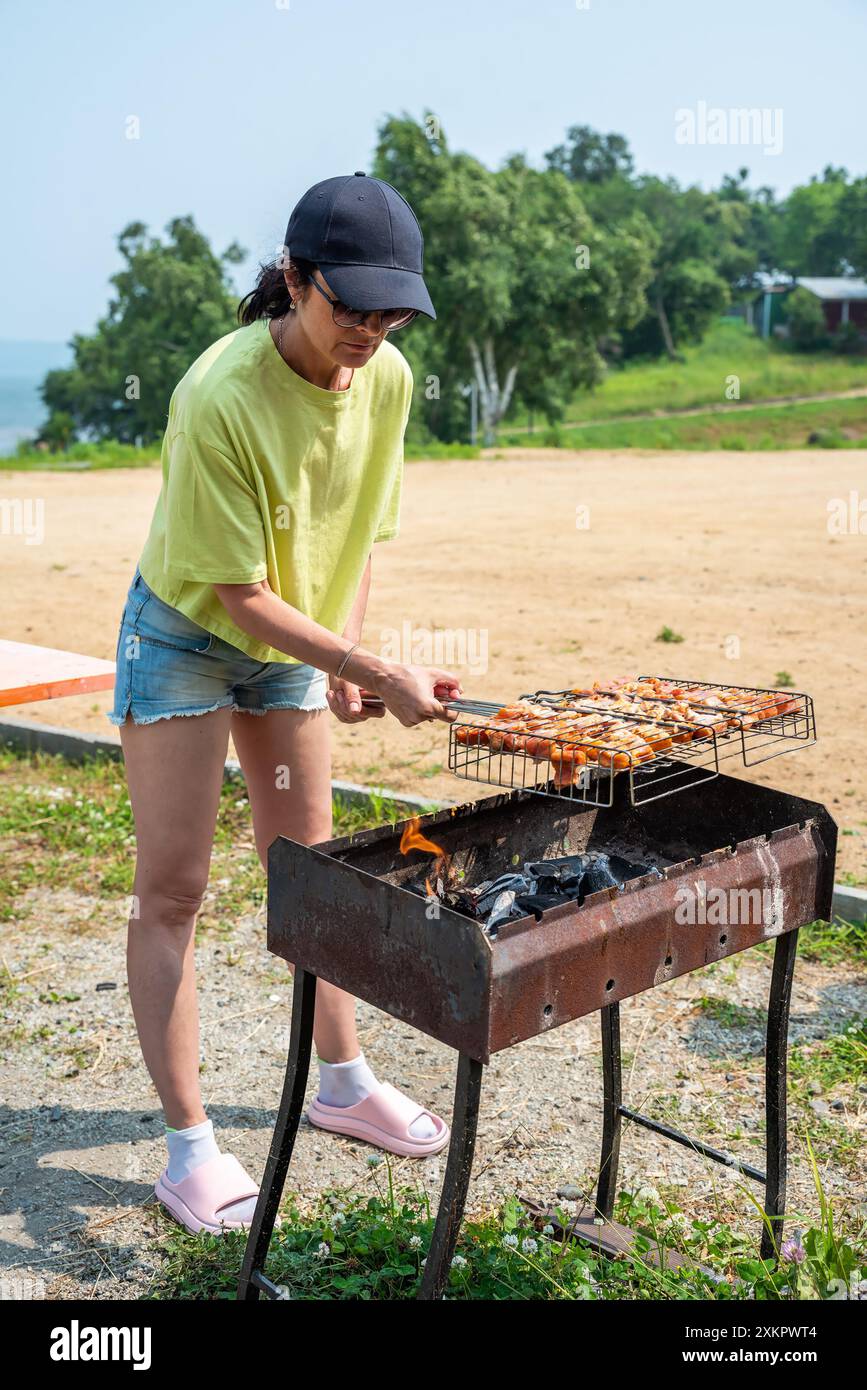 50 years old woman cooking bbq pork outdoors Stock Photo - Alamy