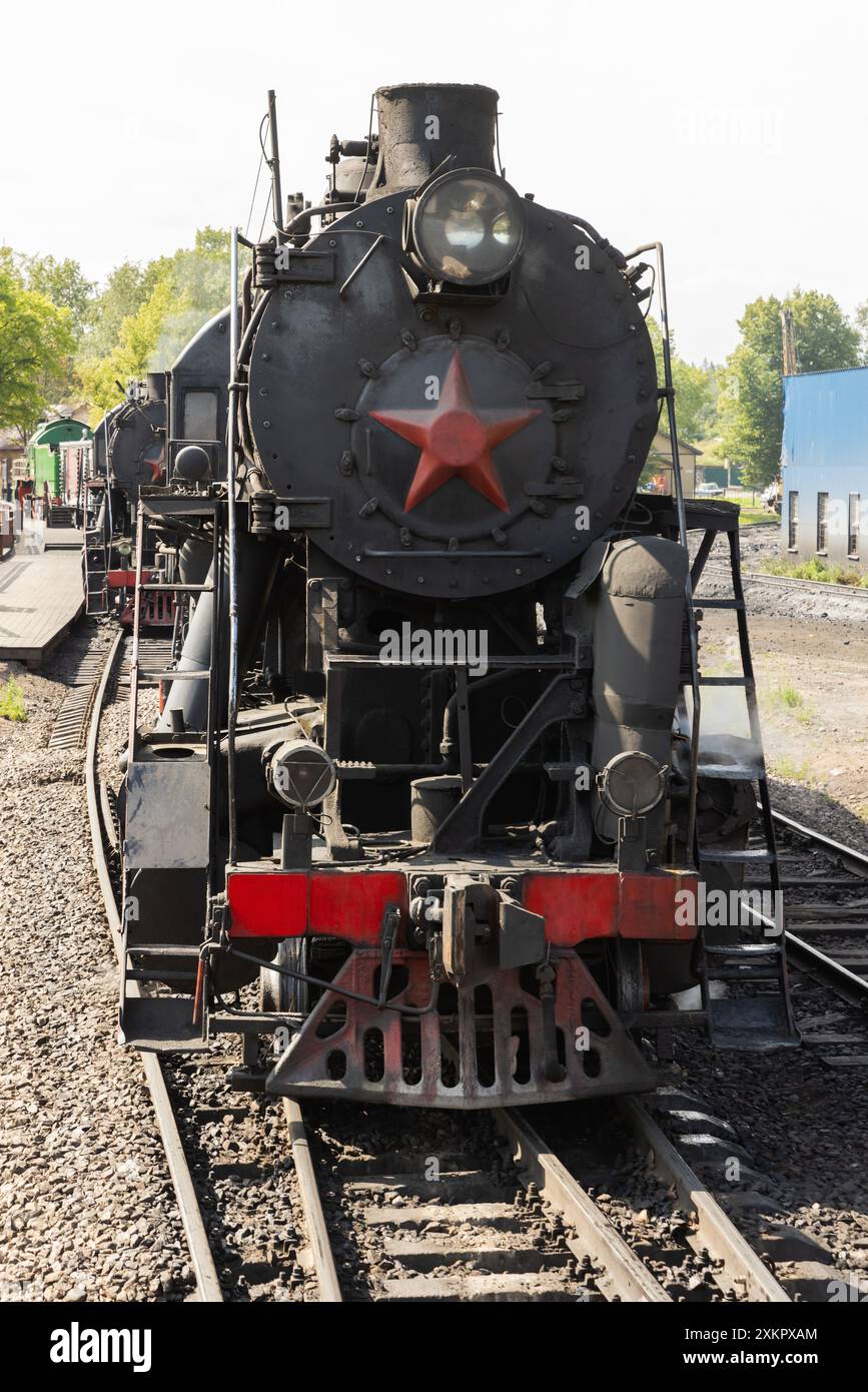 Black steam locomotive with red star from USSR times close up front ...