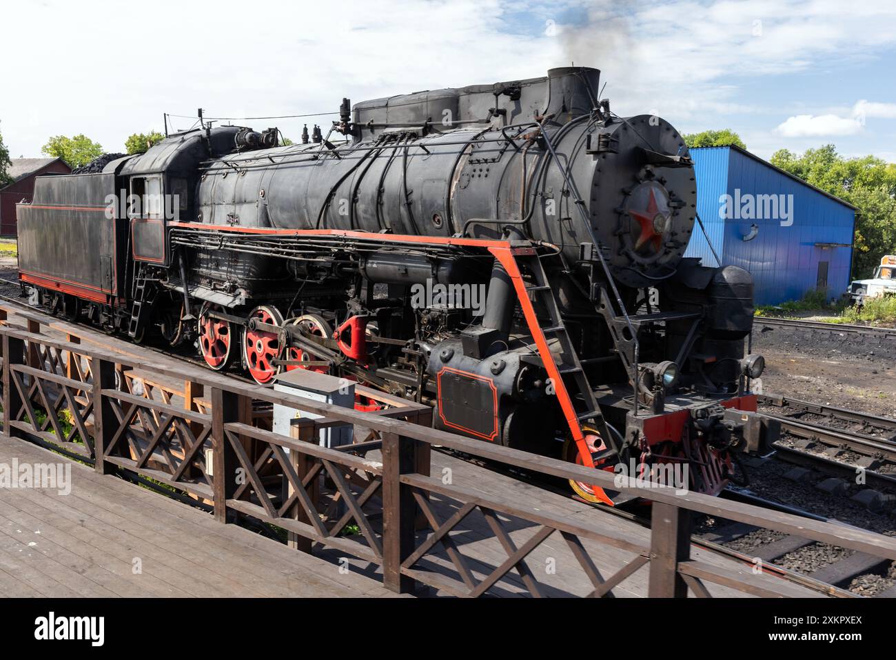 Black retro steam locomotive from USSR times is near the station ...