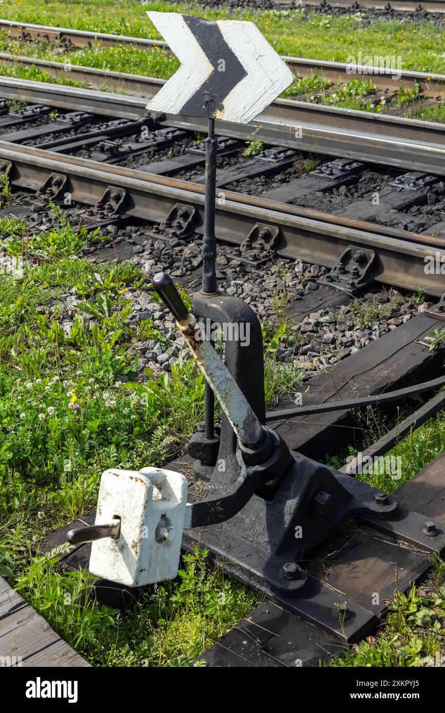 An old manual powered railroad switch with black white direction ...