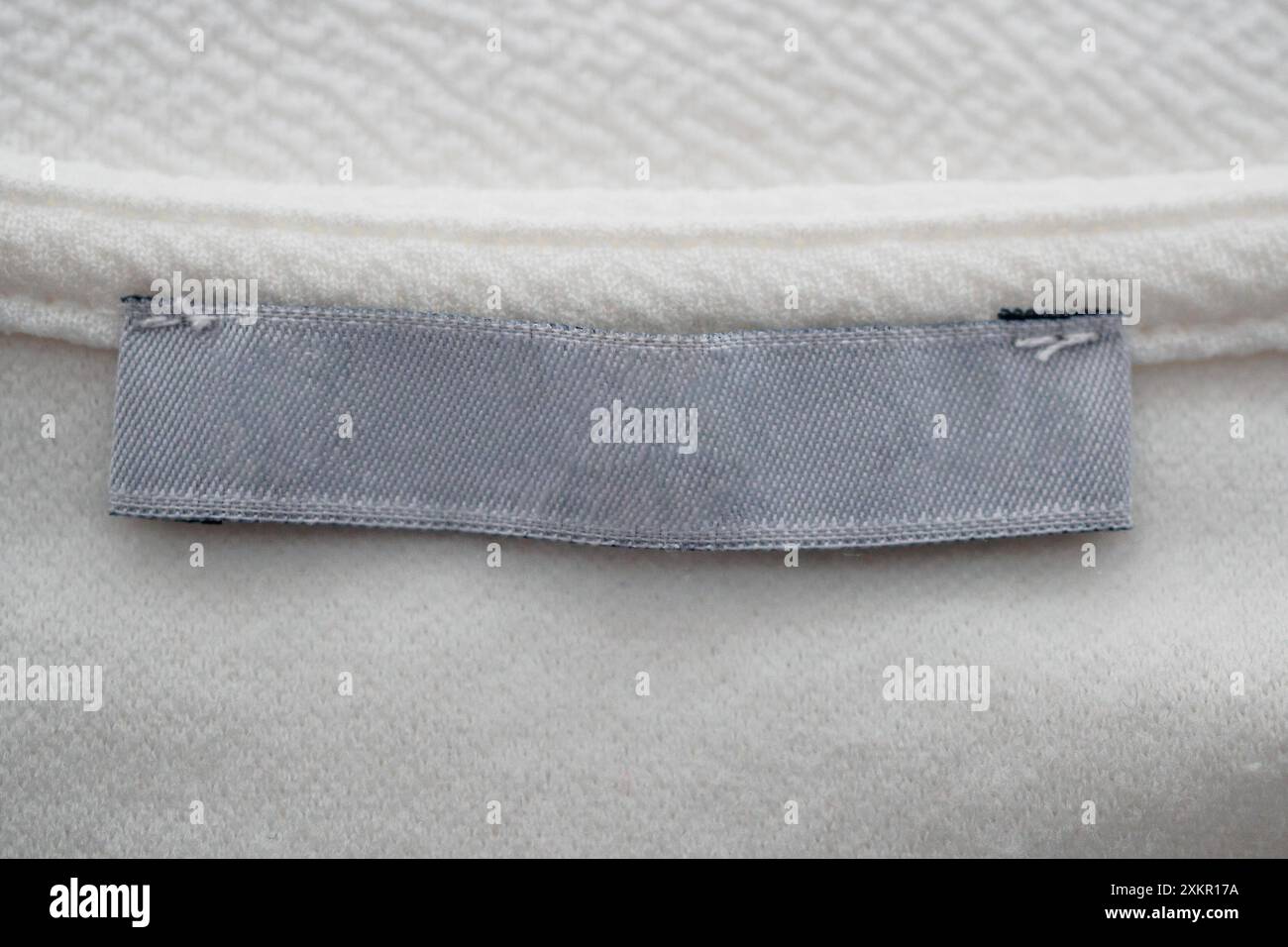 blank clothing label on white fabric texture background Stock Photo - Alamy