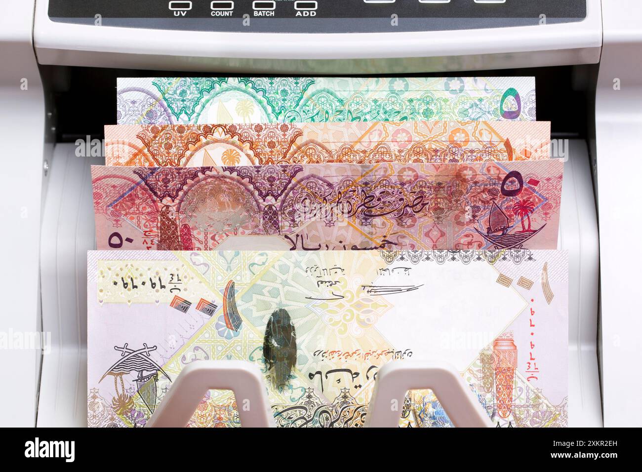 Qatar money riyal counting machine hi-res stock photography and images ...