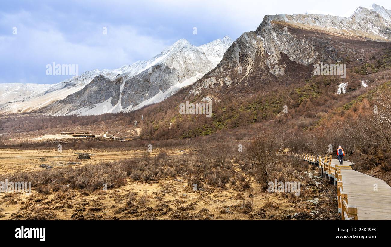 Hiker hiking in the scenic and breathtaking Yading nature reserve ...