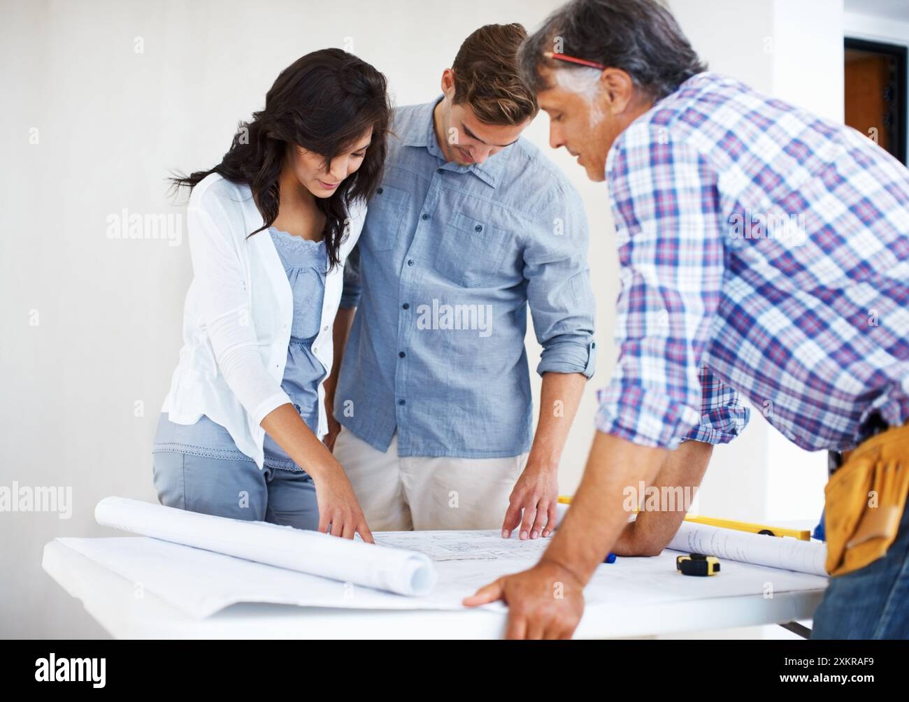 New house, contractor and couple planning blueprint for construction ...