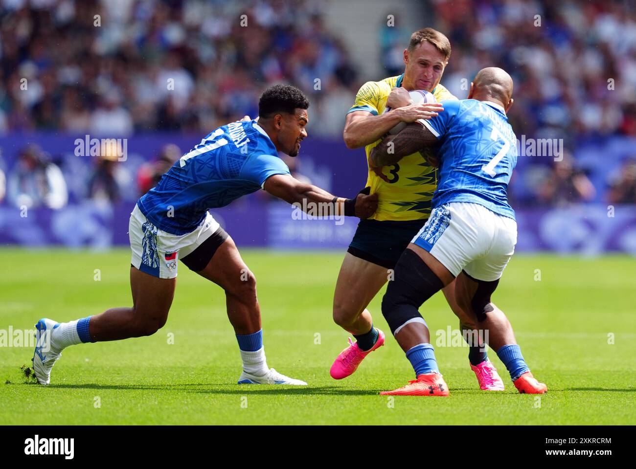 Australia's Corey Toole is tackled by Samoa's Steve Onosai and Lalomilo ...