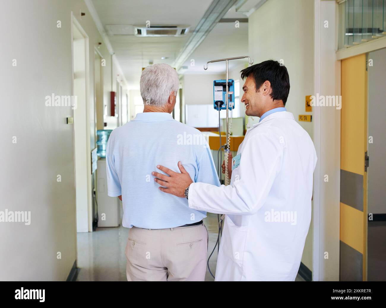 Hospital, walking and doctor with patient, checkup and elderly person ...
