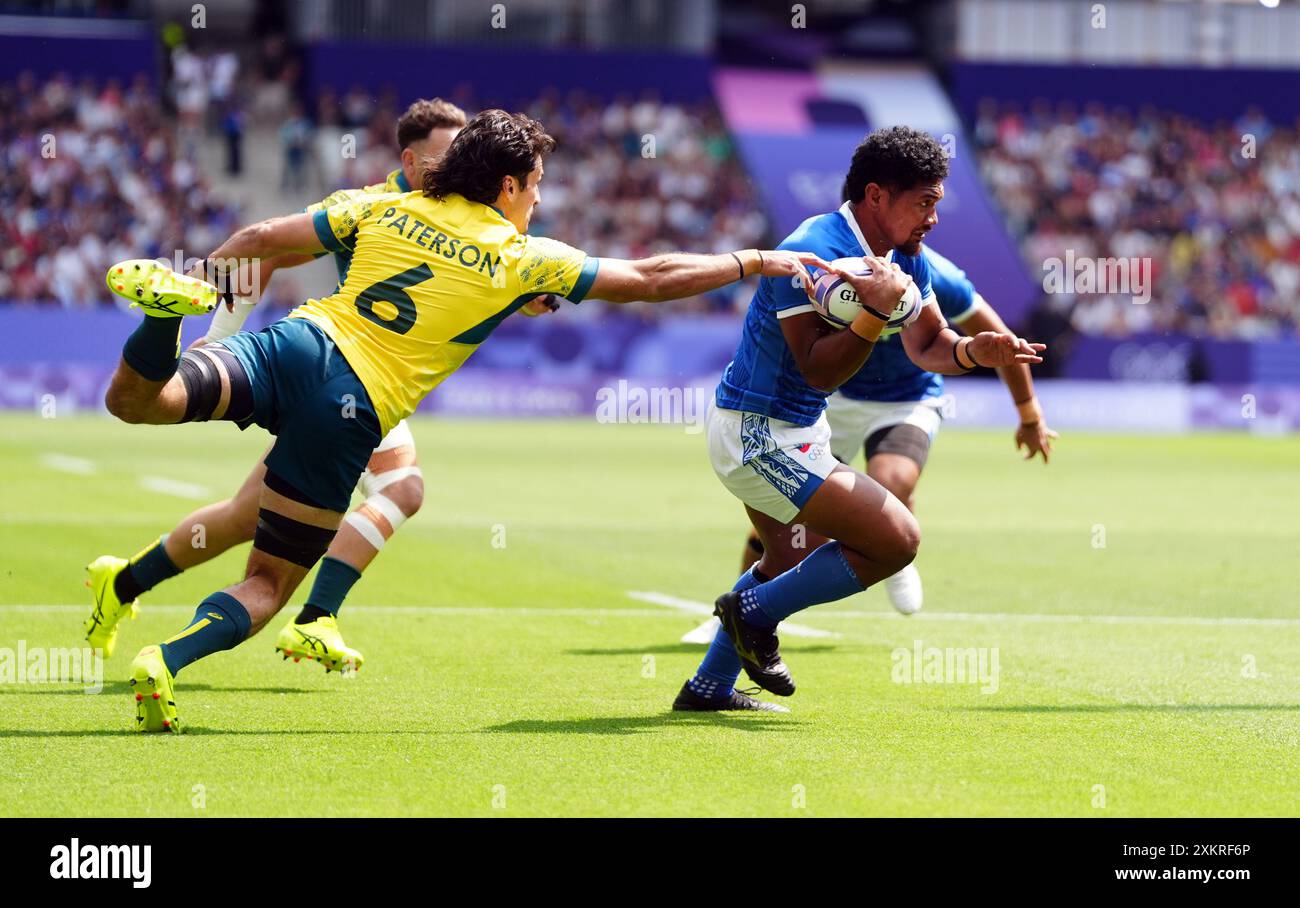 Samoa's Faafoi Falaniko (right) evades a tackle on his way to scoring a ...