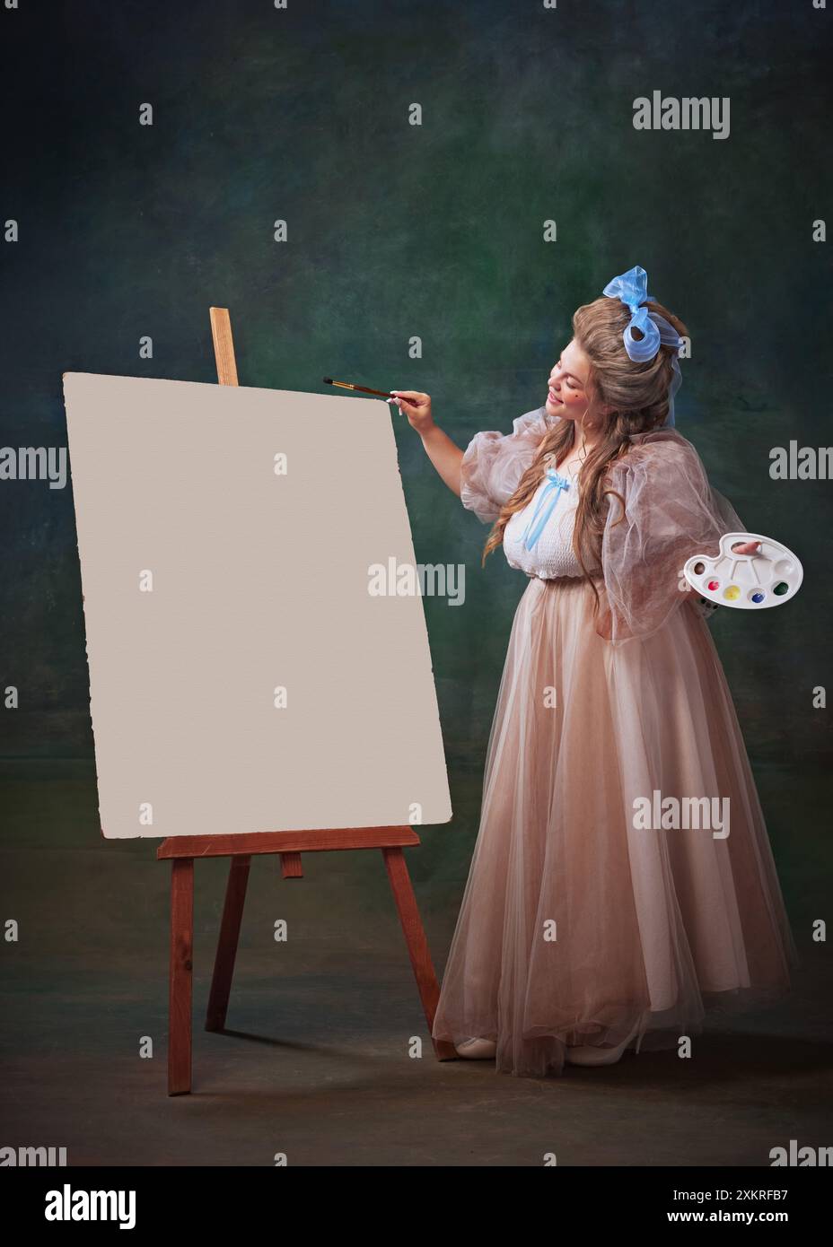 Inspired artist. Happy young woman in period attire standing with ...