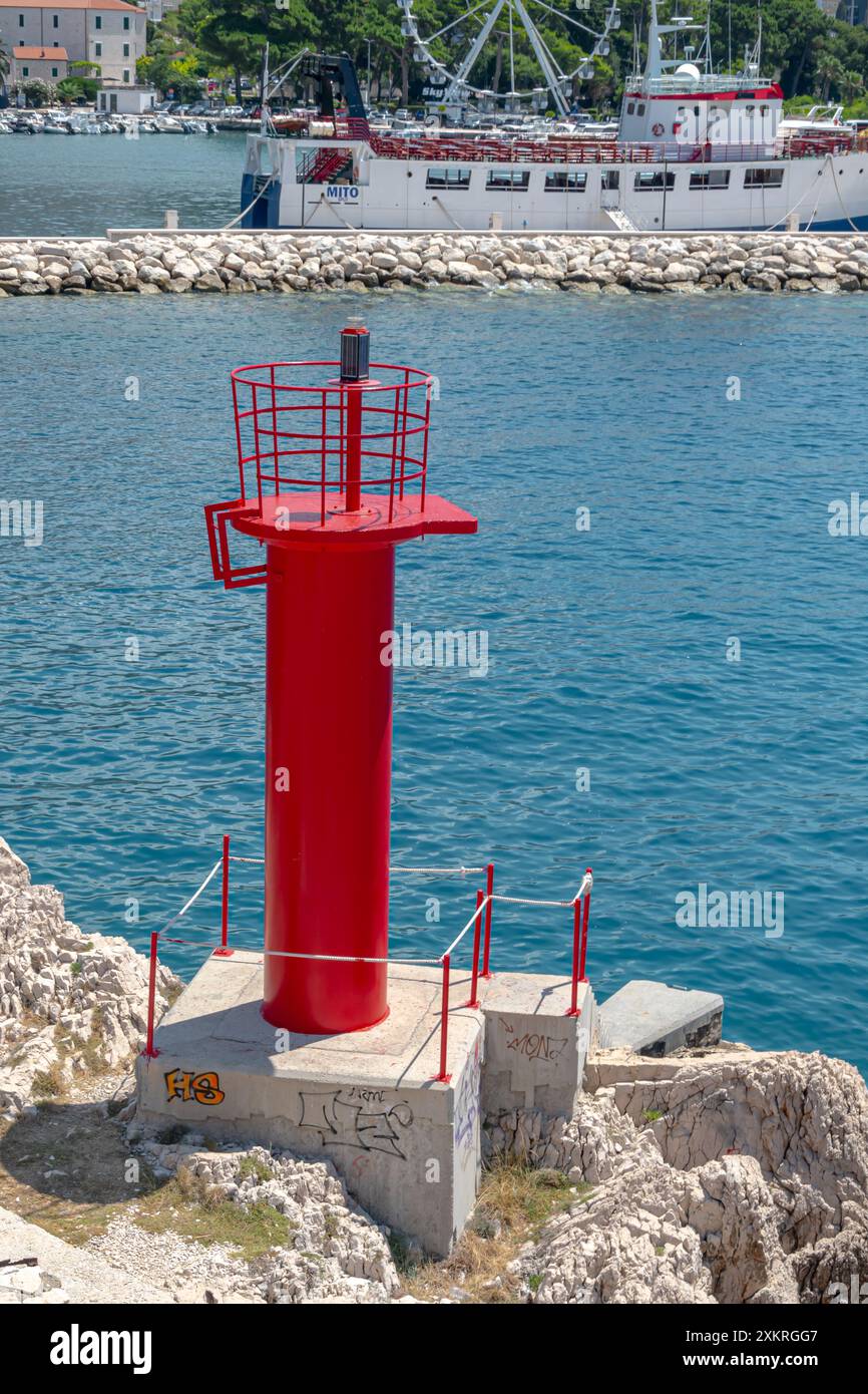 Small modern red lighthouse pole Stock Photo - Alamy