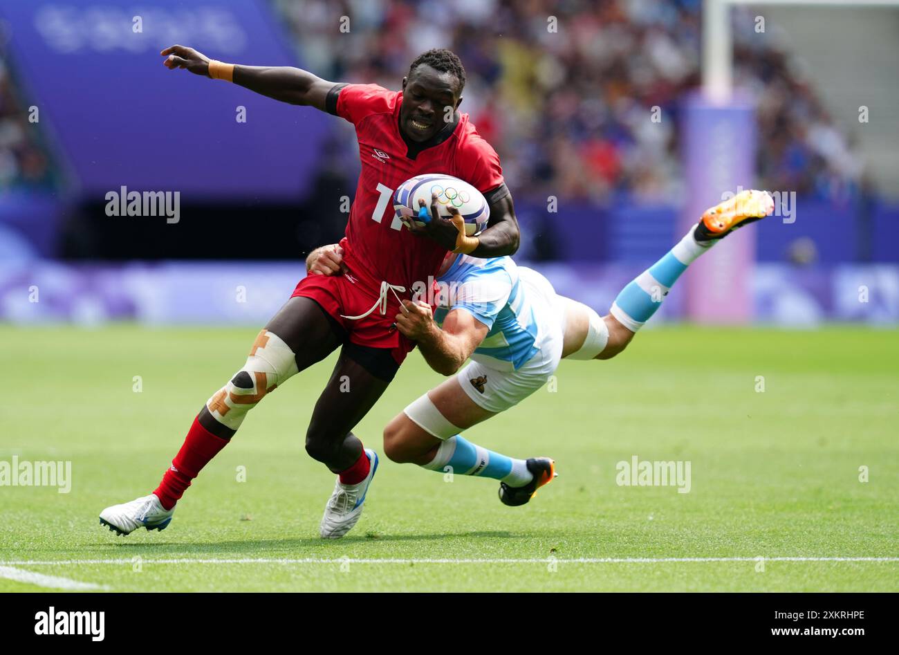 Kenya's Patrick Okongo Odongo (left) is tackled by Santiago Álvarez ...