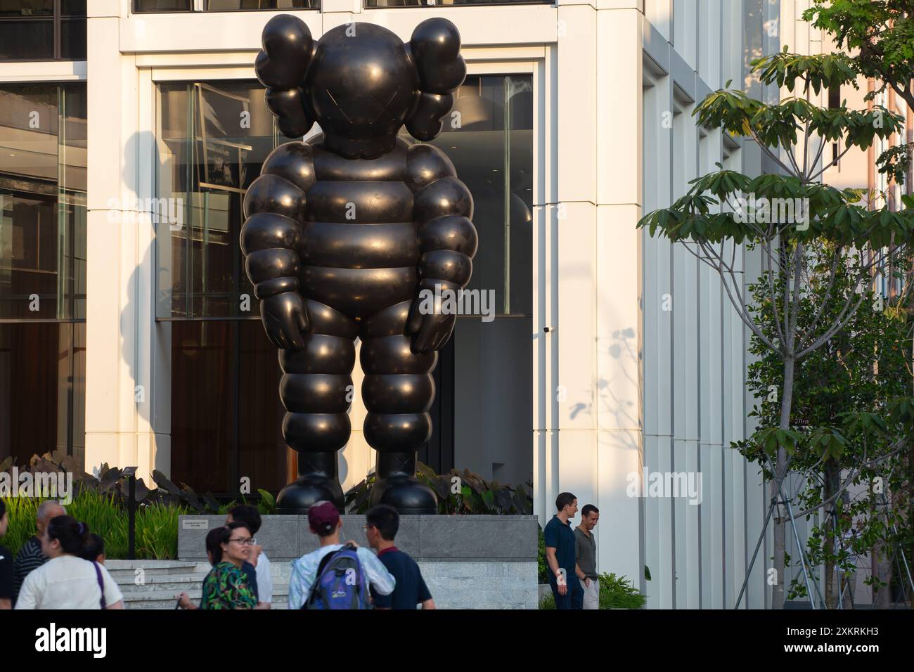 Kaws figurine, like a dystopian Mickey Mouse at an outdoor location ...