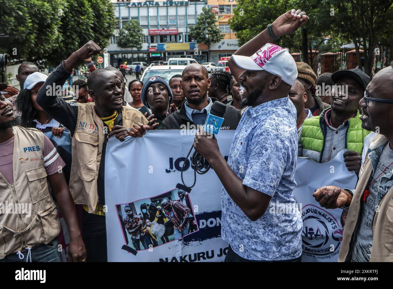 Journalists chant slogans as they march during a protest against the ...