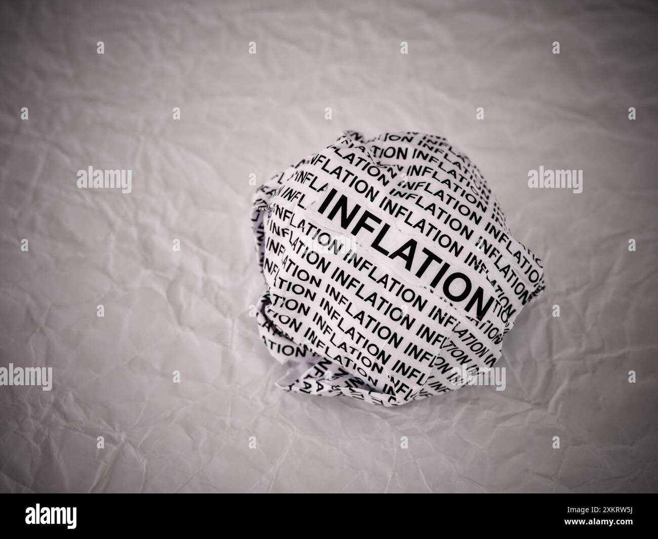 Crumpled paper ball with words Inflation on a crumpled white paper ...