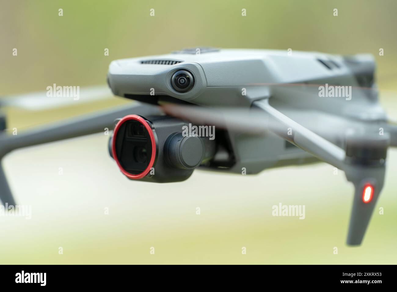 Drone aircraft with blurred fast rotating propellers and video camera ...