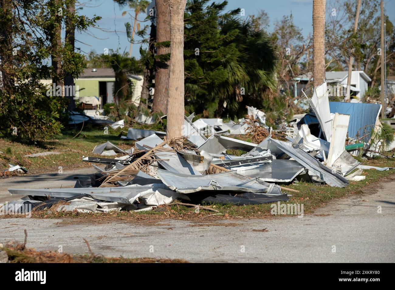 Heaps of debris rubbish on street side near severely damaged by ...