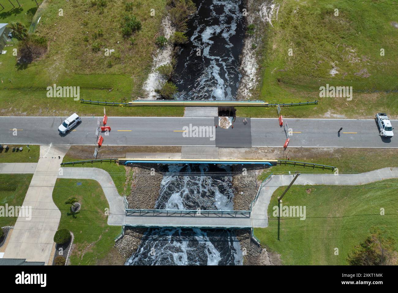 Police car roadblock at damaged road bridge destroyed by river after ...