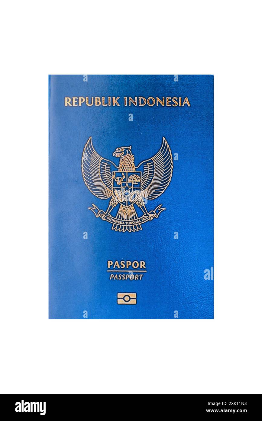 Physical paper international passport of Indonesian citizen on a blue ...