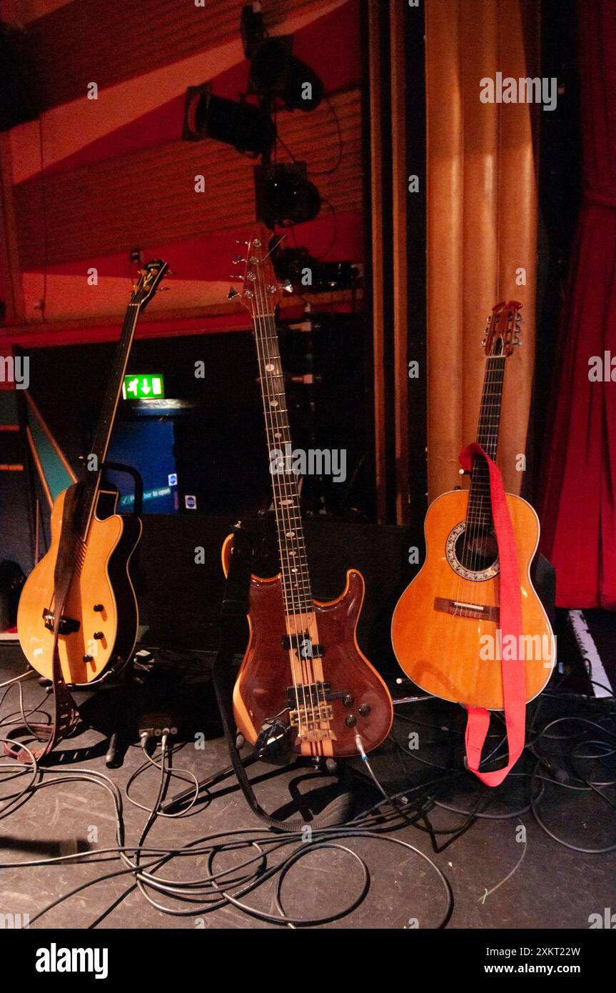 Guitars and bass on stage Stock Photo - Alamy