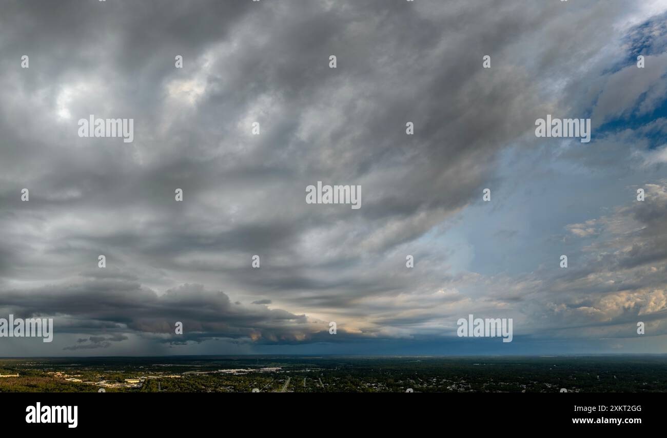 Stormy cumulonimbus clouds forming before thunderstorm on dark sky. Moving and changing ...