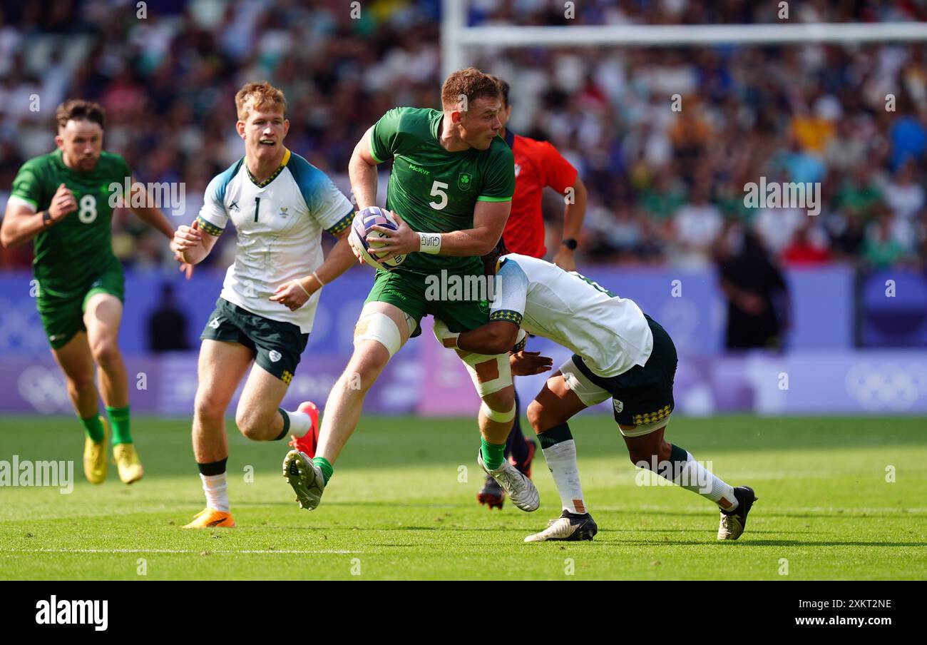 Ireland's Zac Ward is tackled by South Africa's Selvyn Davids during ...